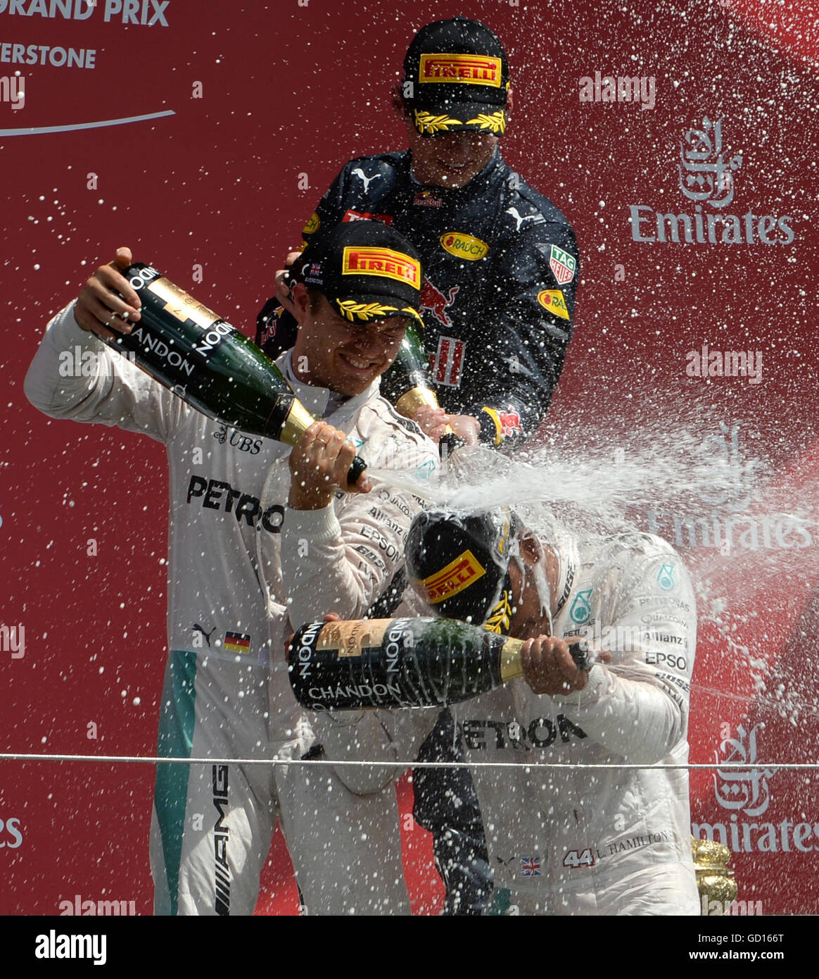 British GP winner Mercedes' Lewis Hamilton is sprayed with champange by ...