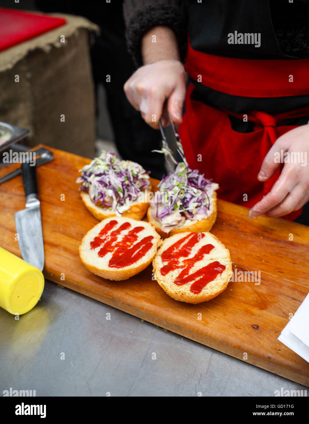 Chef making beef burgers outdoor on open kitchen food festival event ...