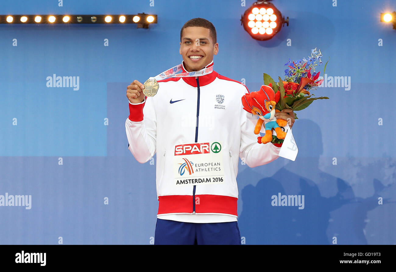 Great Britain's Elliot Giles holds up his bronze medal on the podium ...