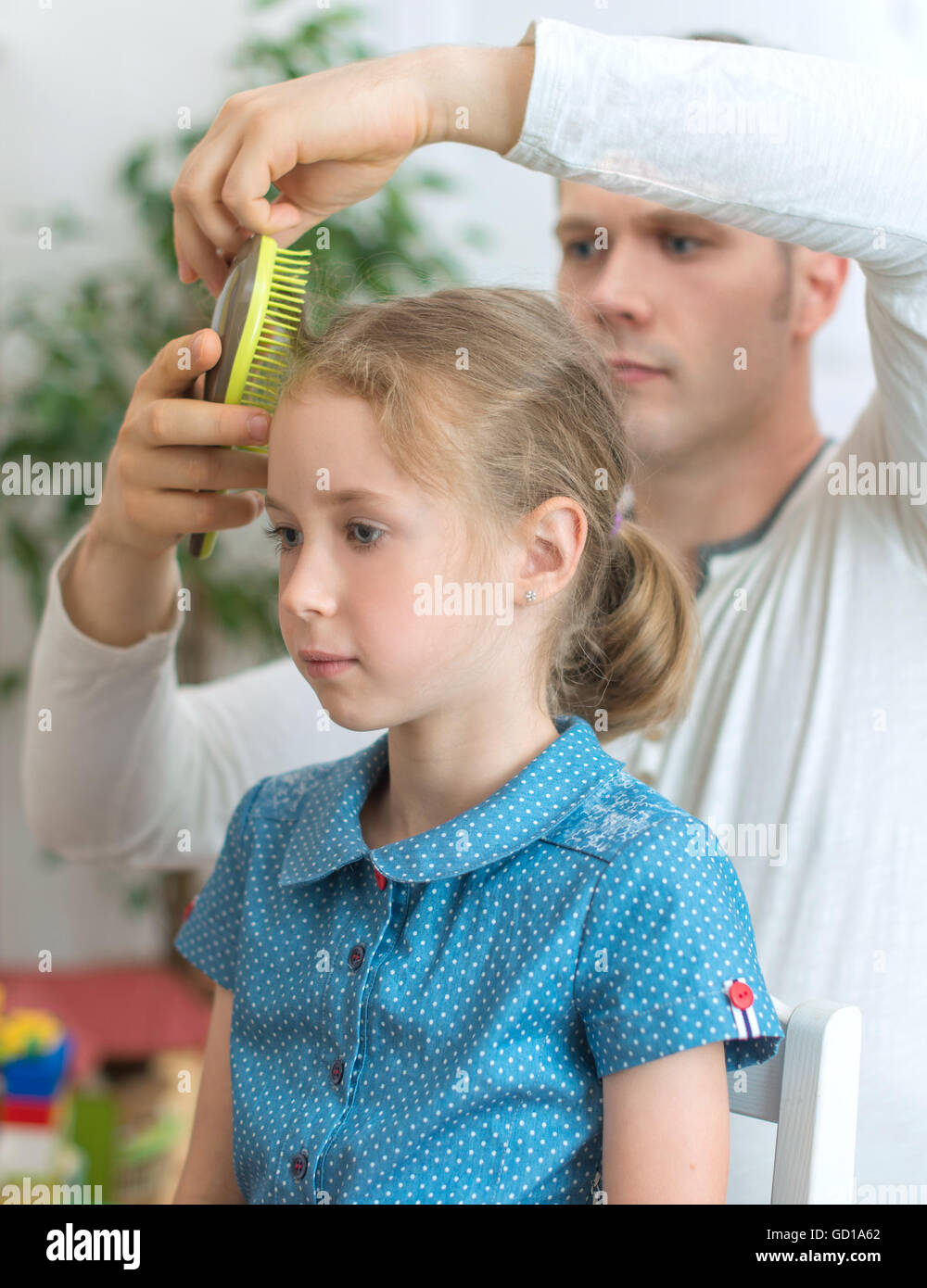 Father brushing hair of his daughter Stock Photo - Alamy