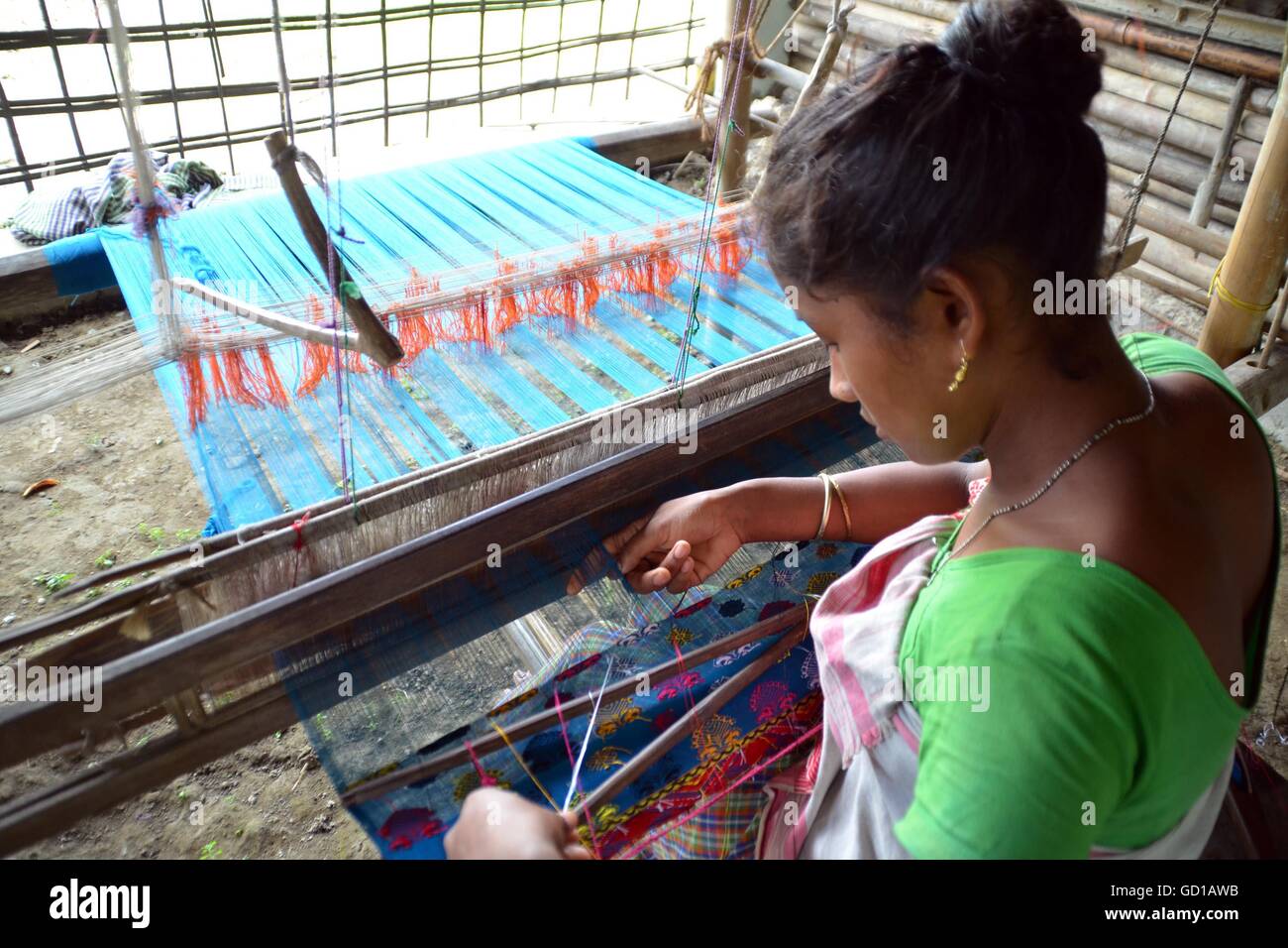 Golaghat, India. 10th July, 2016. A mishing tribal woman busy in ...