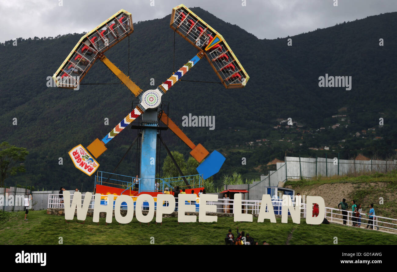 Kathmandu, Nepal. 10th July, 2016. Nepali people enjoy swing at Whoopee ...