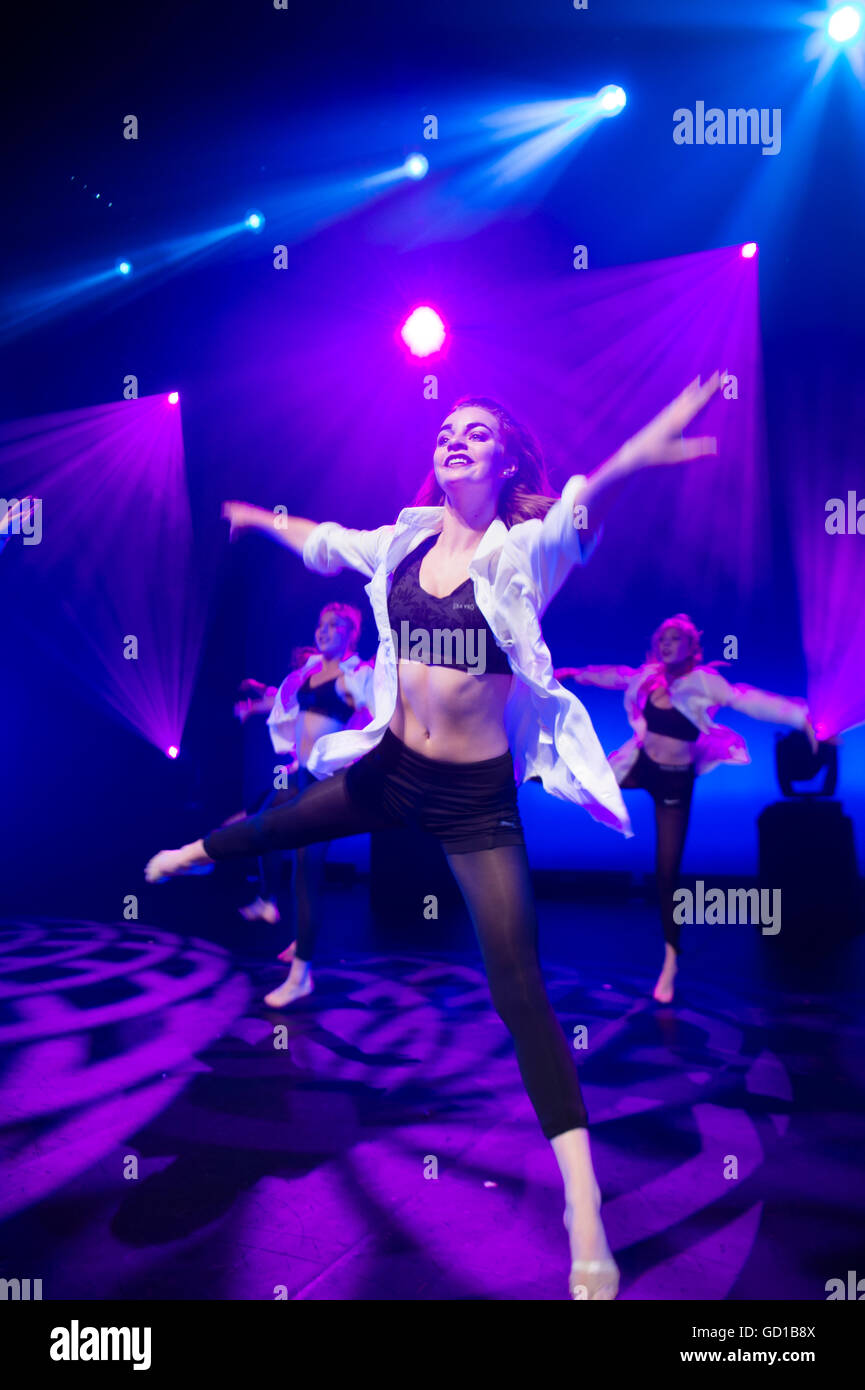 A group of teenage girl dancers performing in a showcase of ...