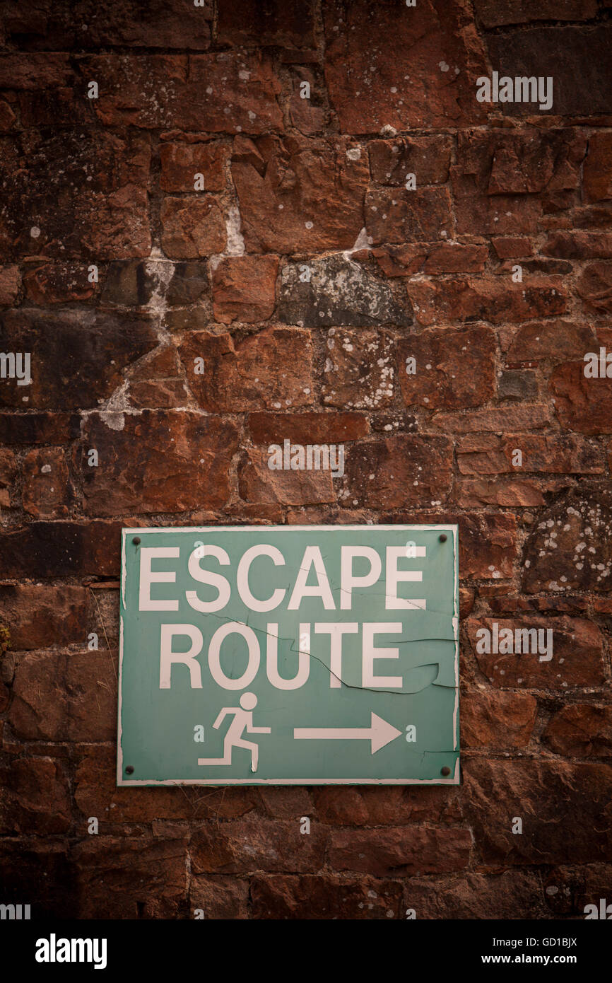 Color image of an Escape Route indicator on a brick wall Stock Photo ...