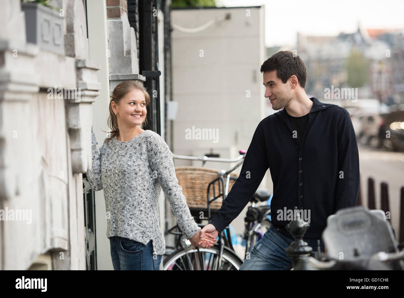 young couple, man and woman in Amsterdam, Netherlands, standing in ... young couple, man and woman in Amsterdam, Netherlands, standing in ...