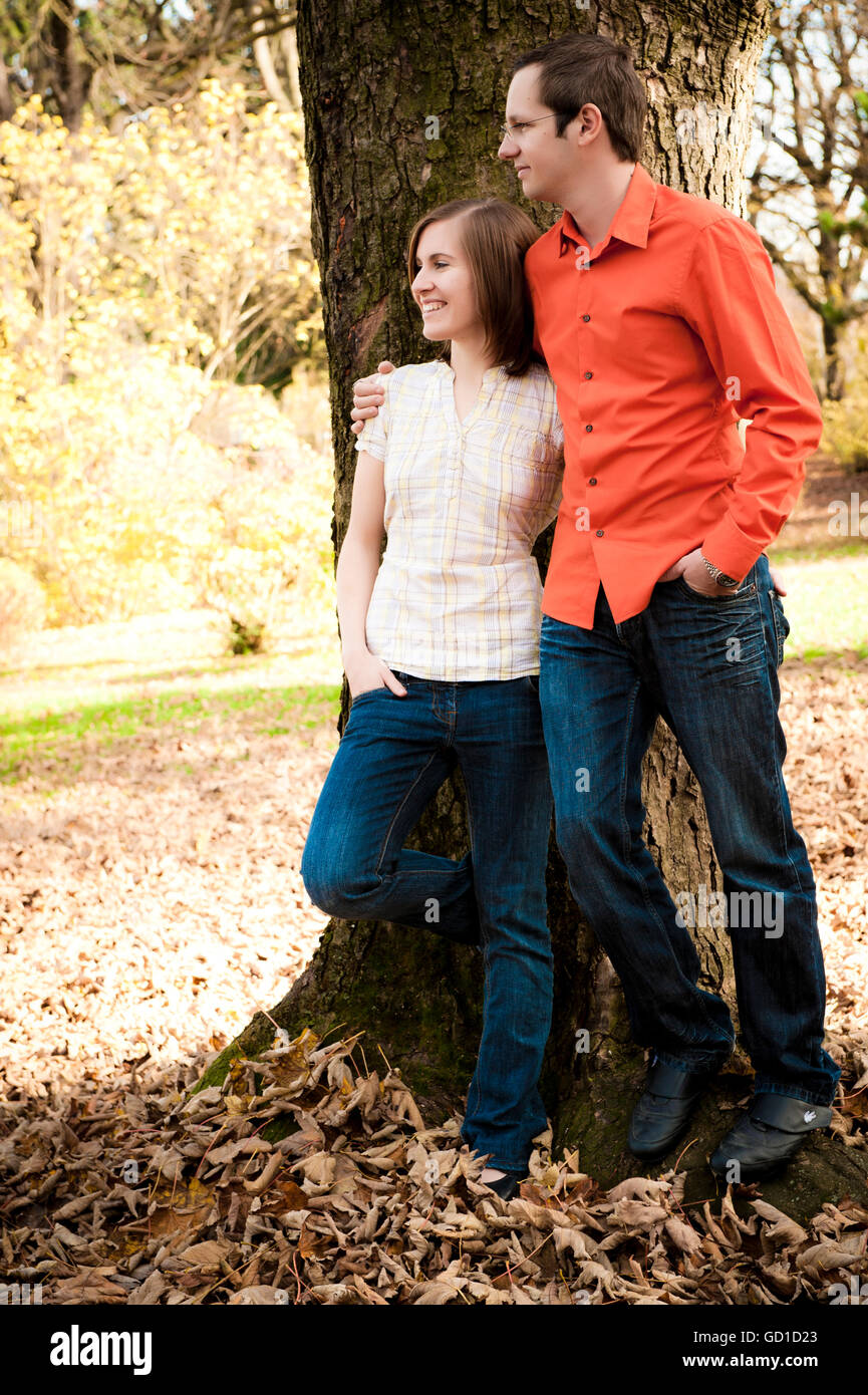 Couple leaning against a tree hi-res stock photography and images - Alamy
