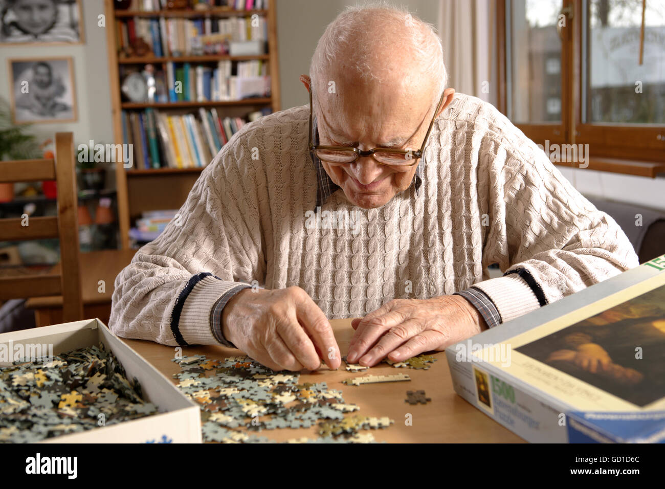 Elderly man, senior, 92, doing a puzzle Stock Photo - Alamy