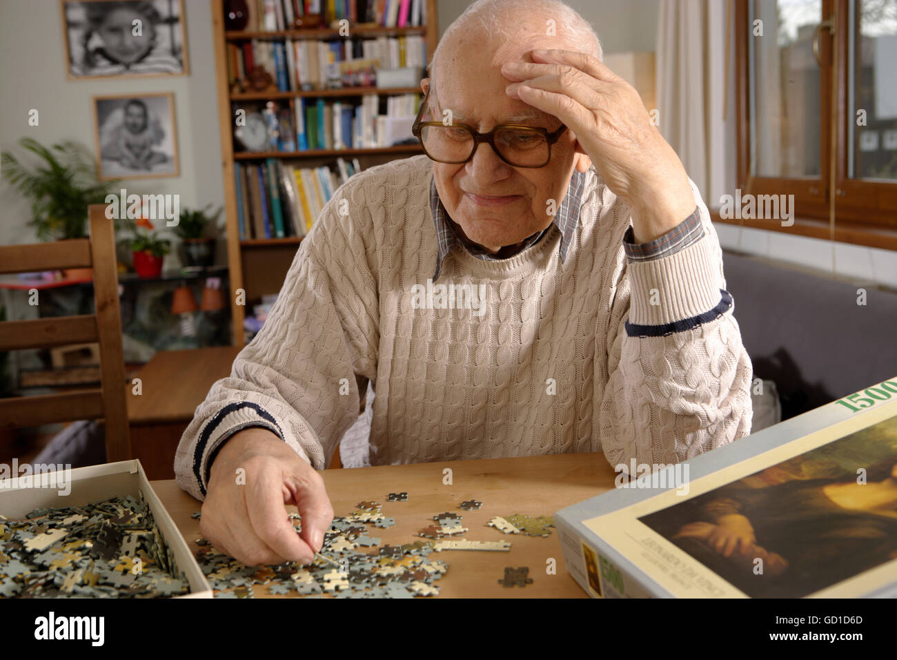 Elderly man, senior, 92, doing a puzzle Stock Photo - Alamy