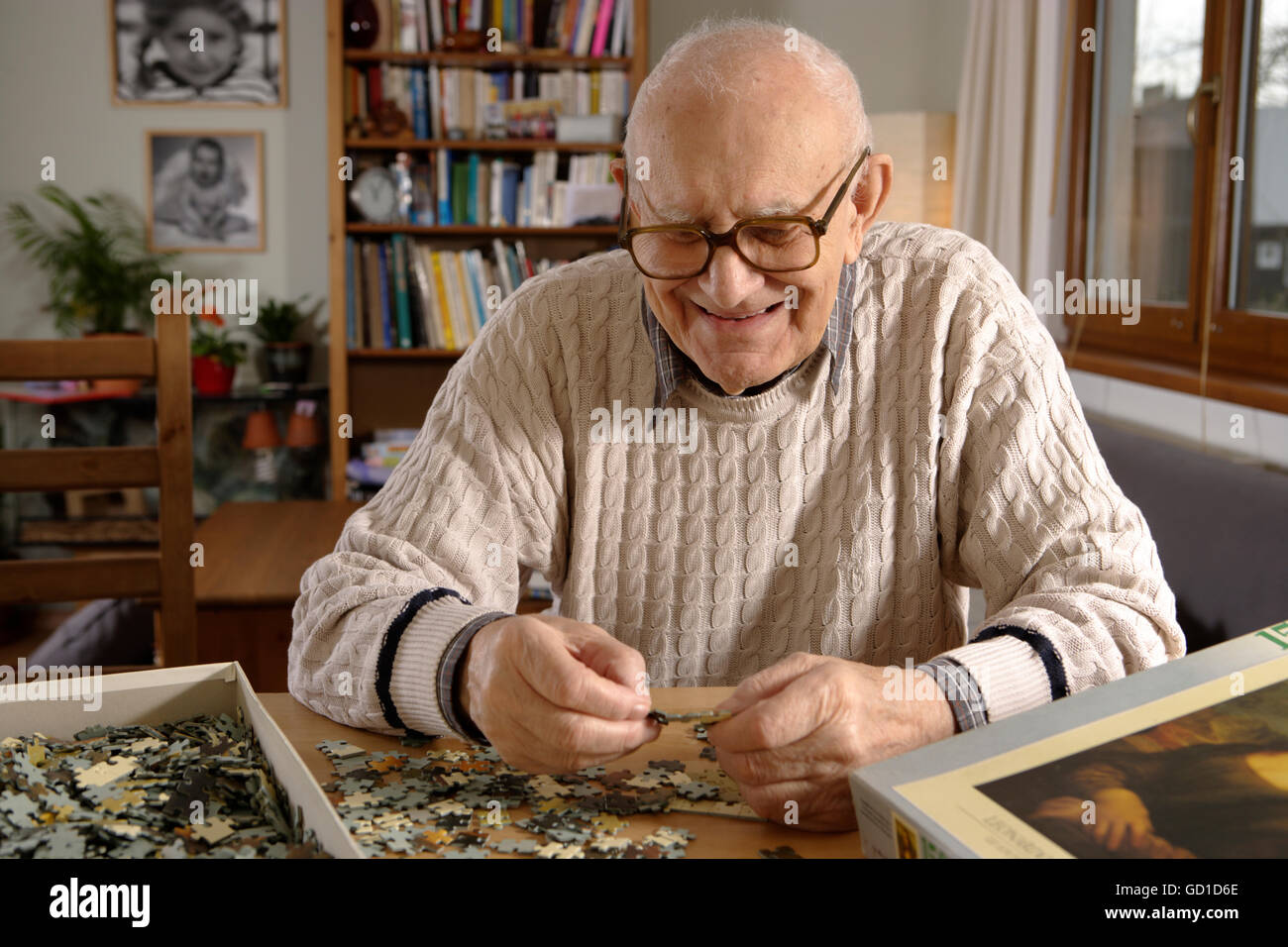 Elderly man, senior, 92, doing a puzzle Stock Photo - Alamy