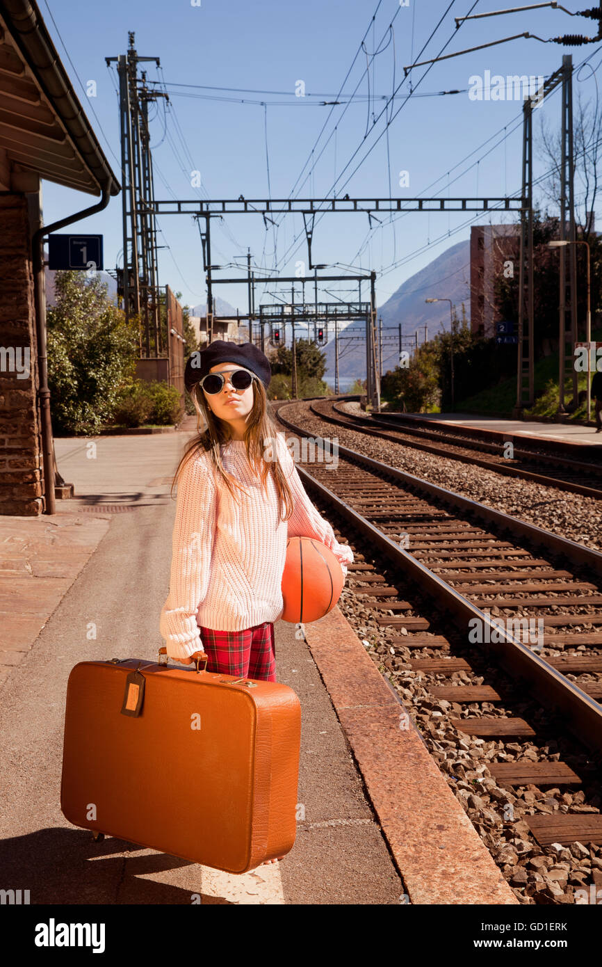 little girl waiting for the train in a deserted station Stock Photo - Alamy