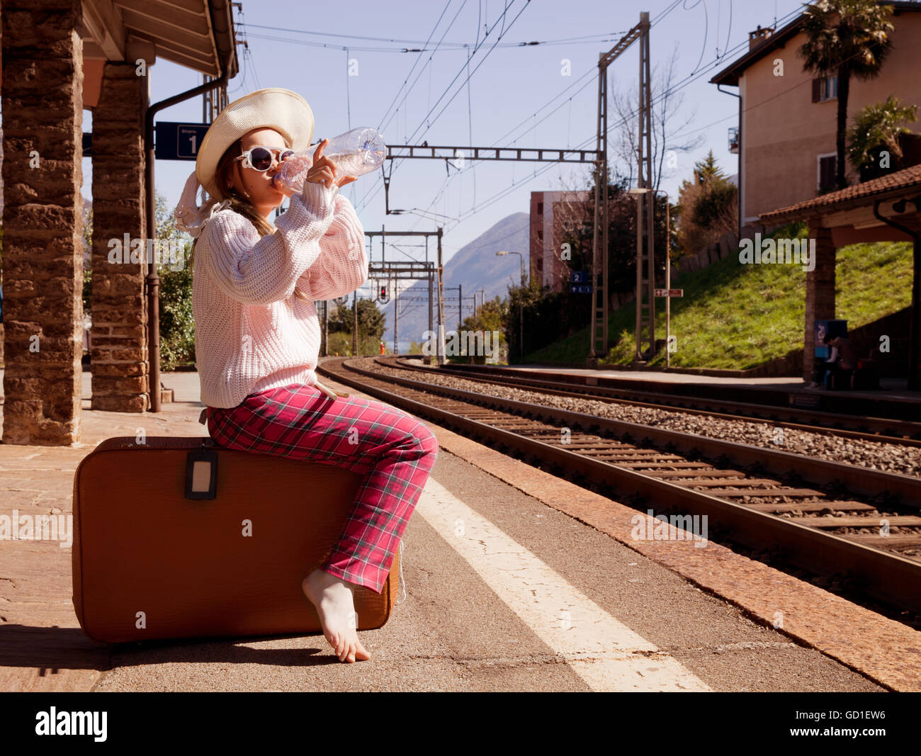 little girl waiting for the train in a deserted station Stock Photo - Alamy