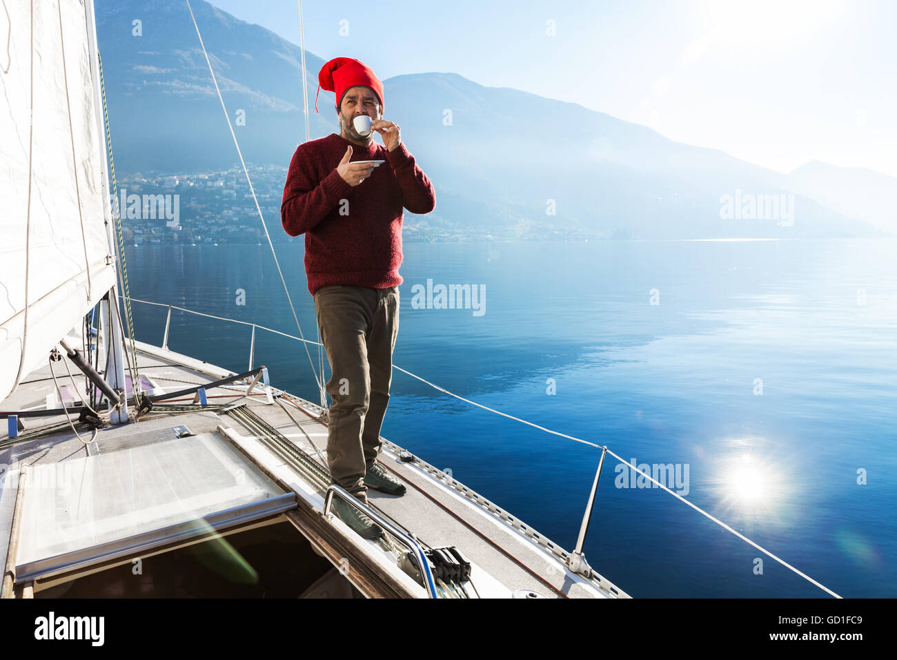 man makes a coffee break aboard his sailboat Stock Photo - Alamy