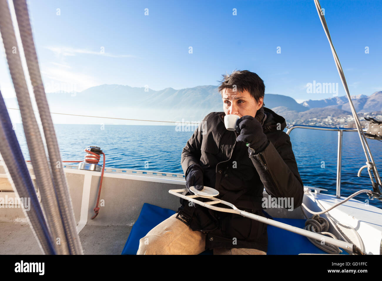 woman makes a coffee break aboard his sailboat Stock Photo - Alamy
