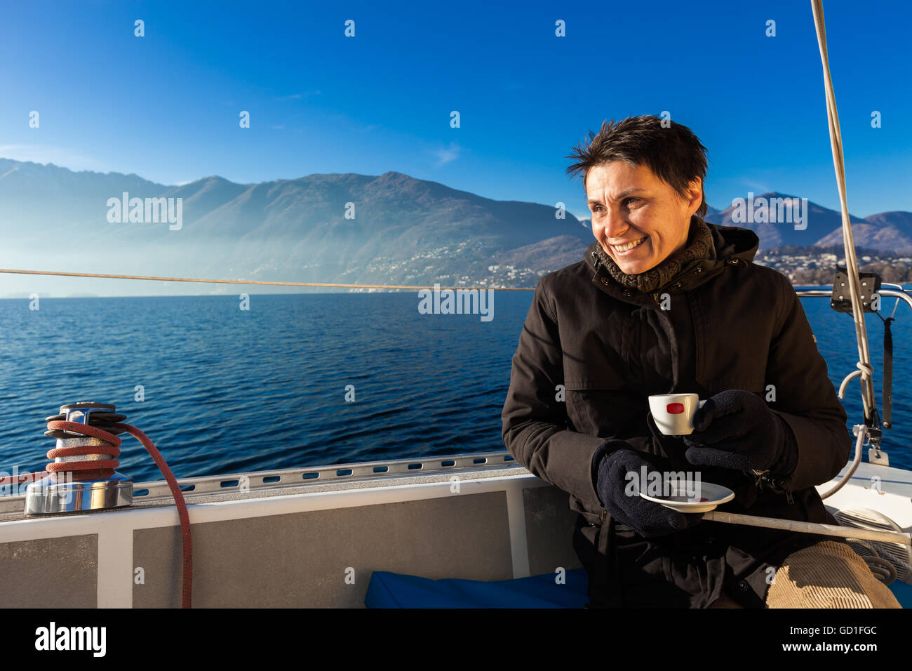woman makes a coffee break aboard his sailboat Stock Photo - Alamy