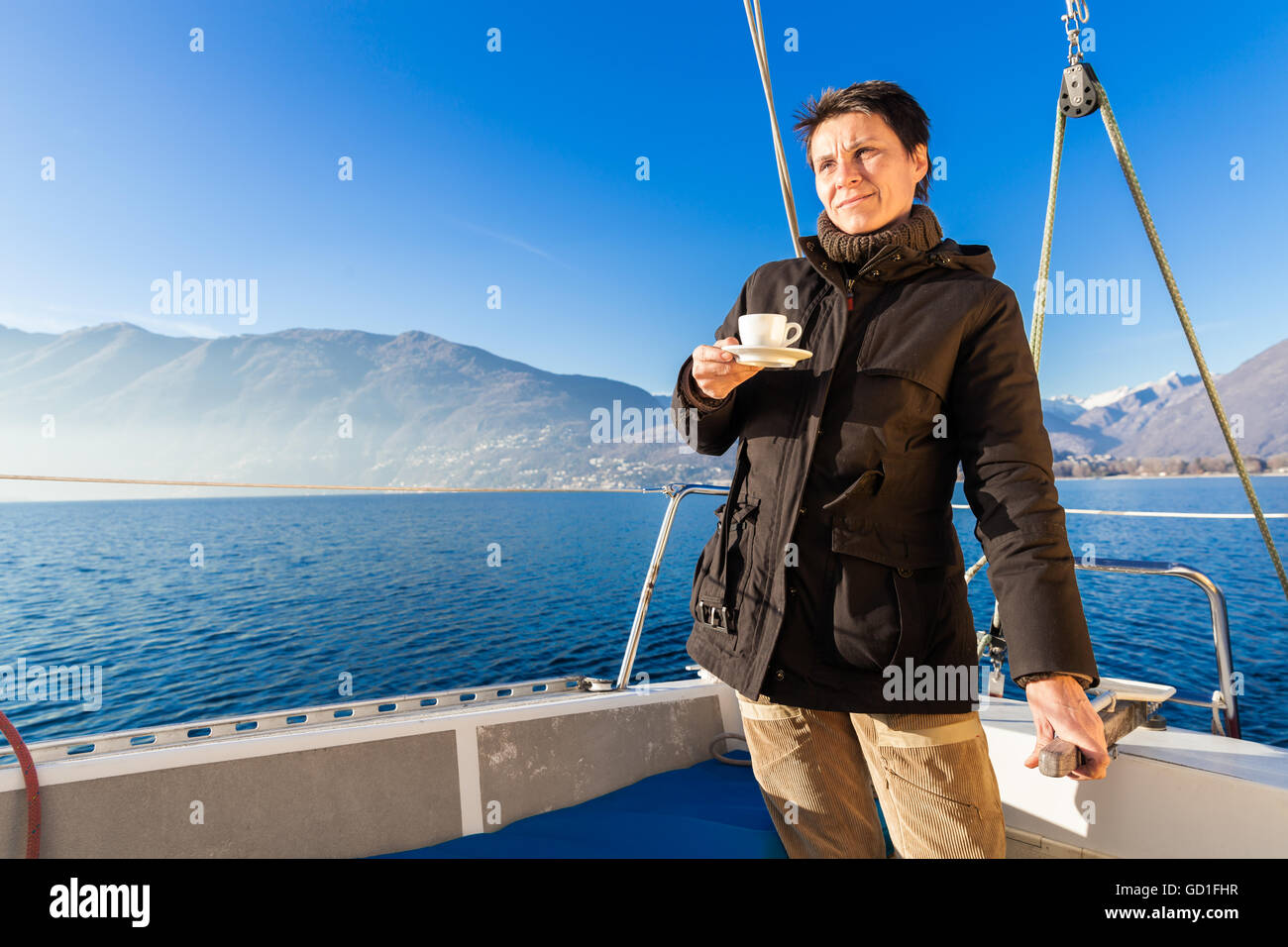 woman makes a coffee break aboard his sailboat Stock Photo - Alamy