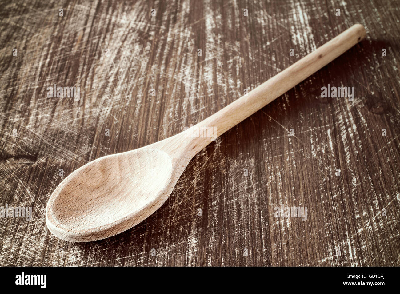 Big wooden spoon on the scratched wooden table Stock Photo - Alamy