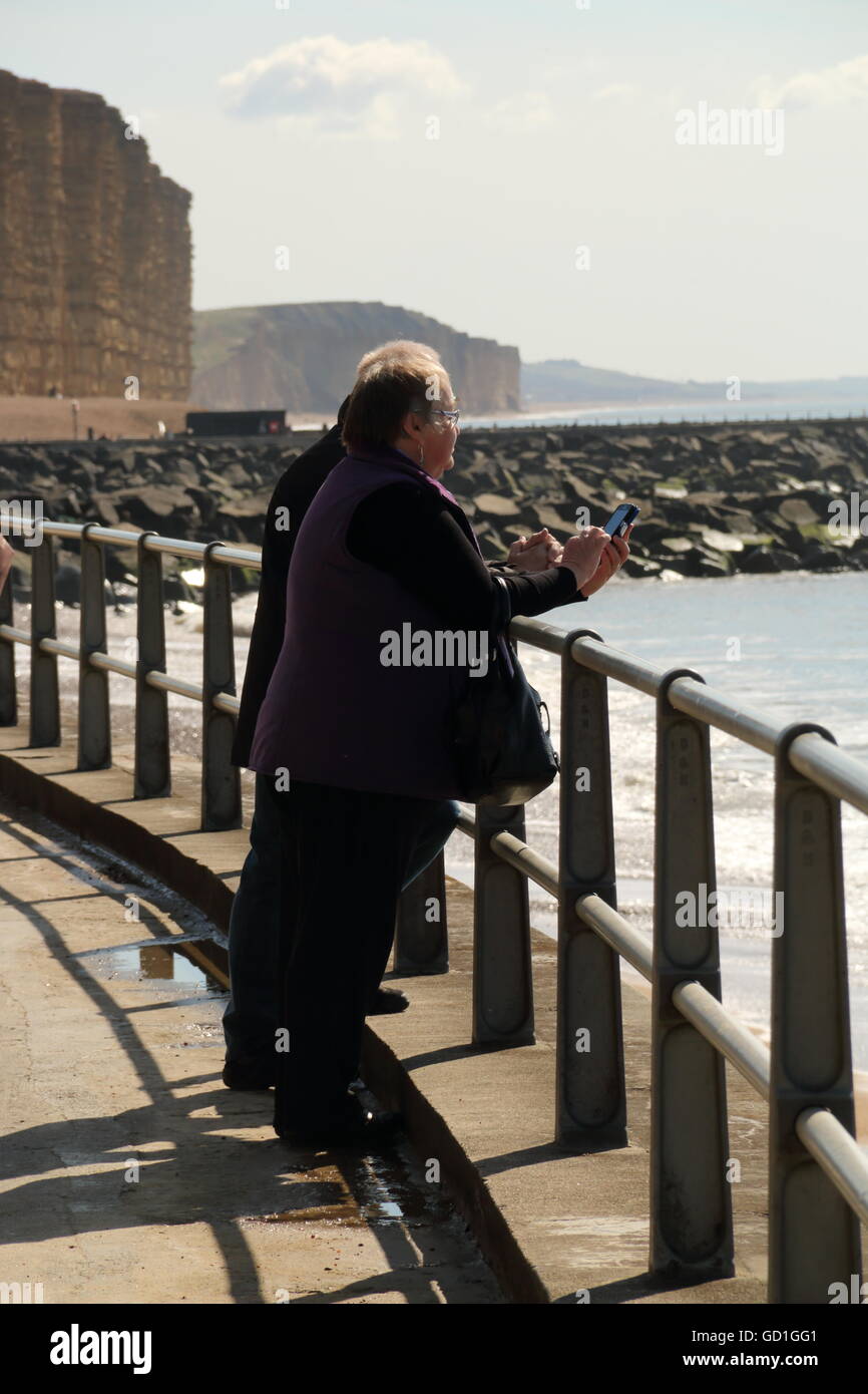 Couple enjoying view,West Bay,Dorset,UK Stock Photo - Alamy
