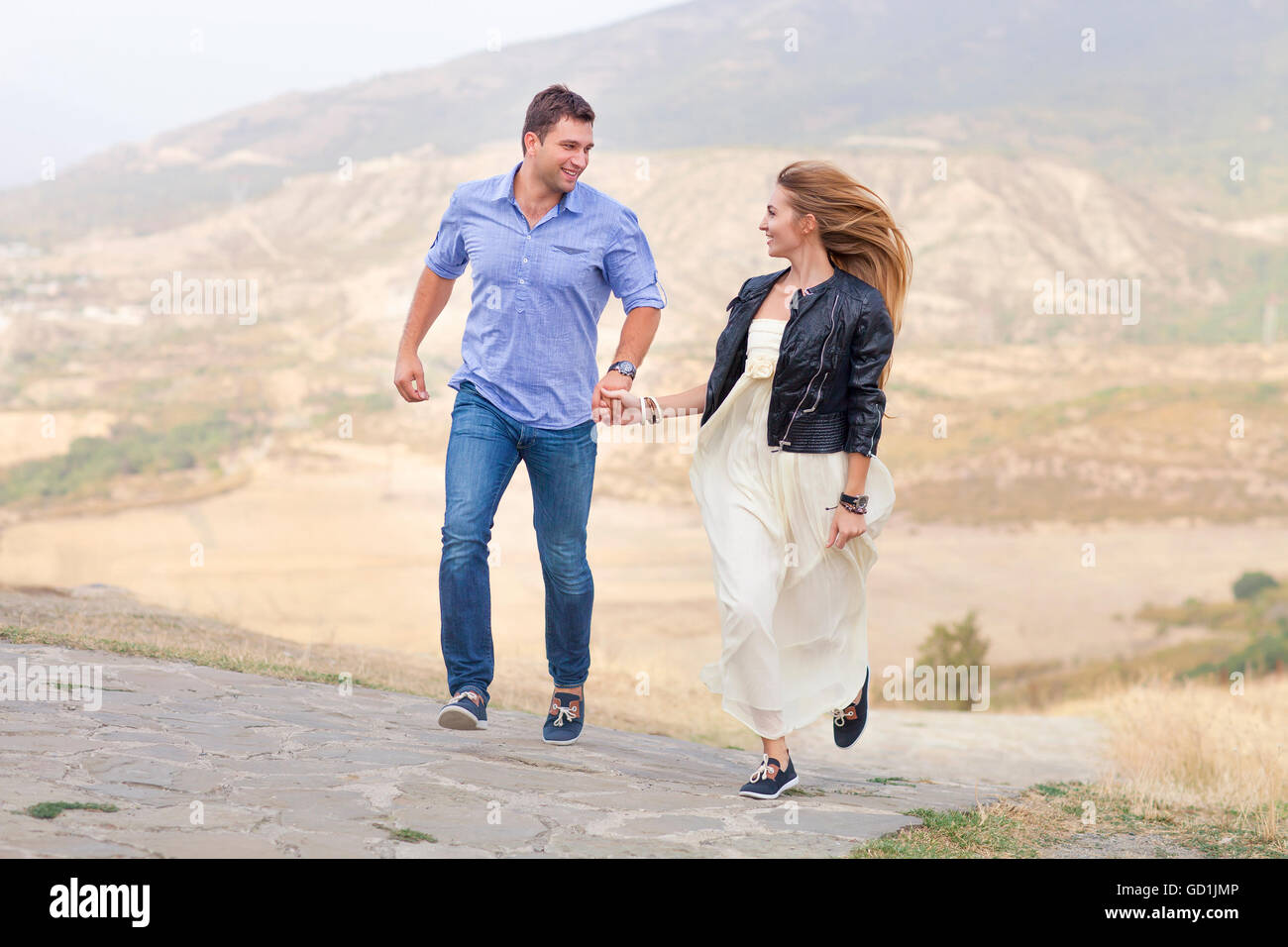 Beautiful happy smiling running couple in love outdoors Stock Photo - Alamy