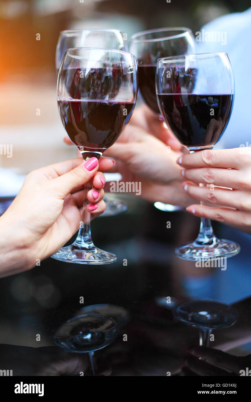 Close up of hands of a friends toasting in restaurant Stock Photo - Alamy