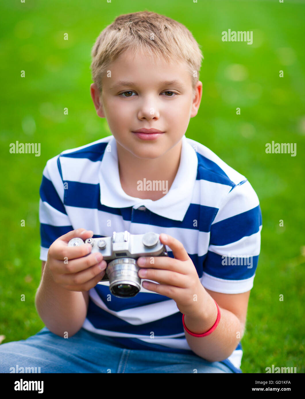 Happy smiling little boy with retro vintage camera in summer park Stock ...
