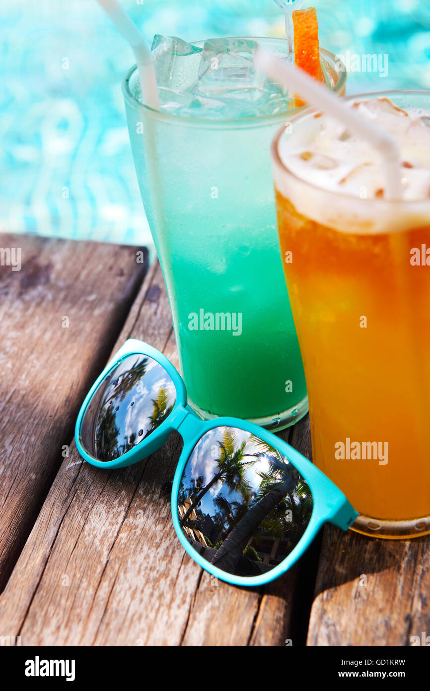 Cocktails with sunglasses near the swimming pool on the background of ...