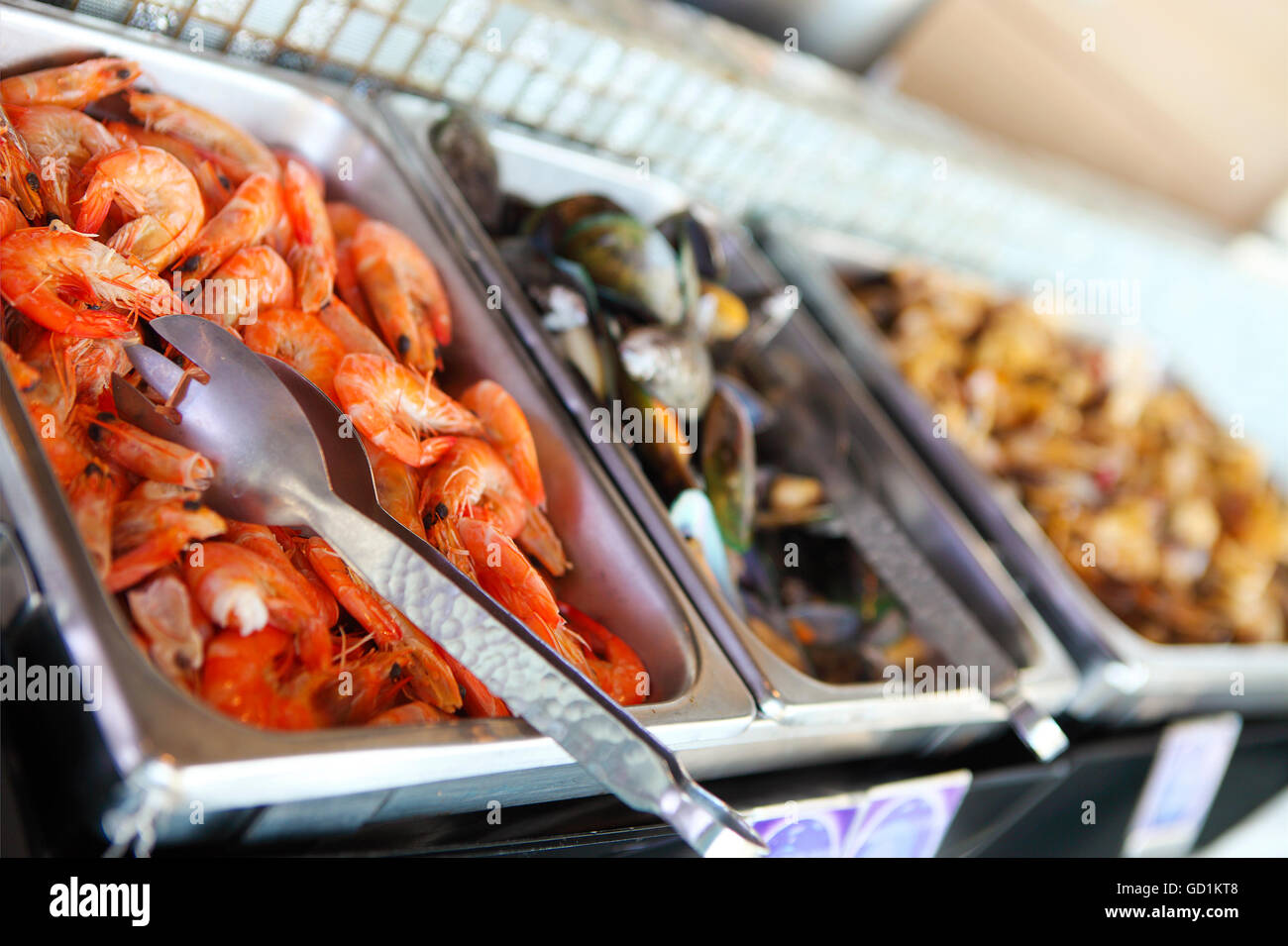 Buffet table with seafood with shrimps, fried calamari rings and ...