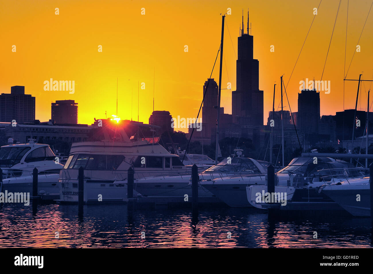 The setting sun creates a glow in the sky and into Chicago's Burnham ...