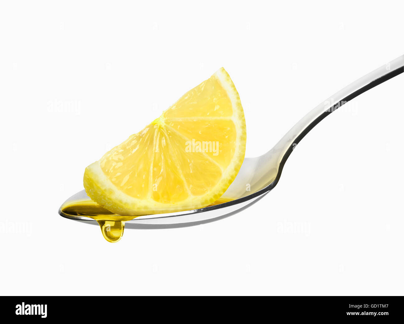 Lemon wedge on a spoon on a white background with a droplet of liquid ...