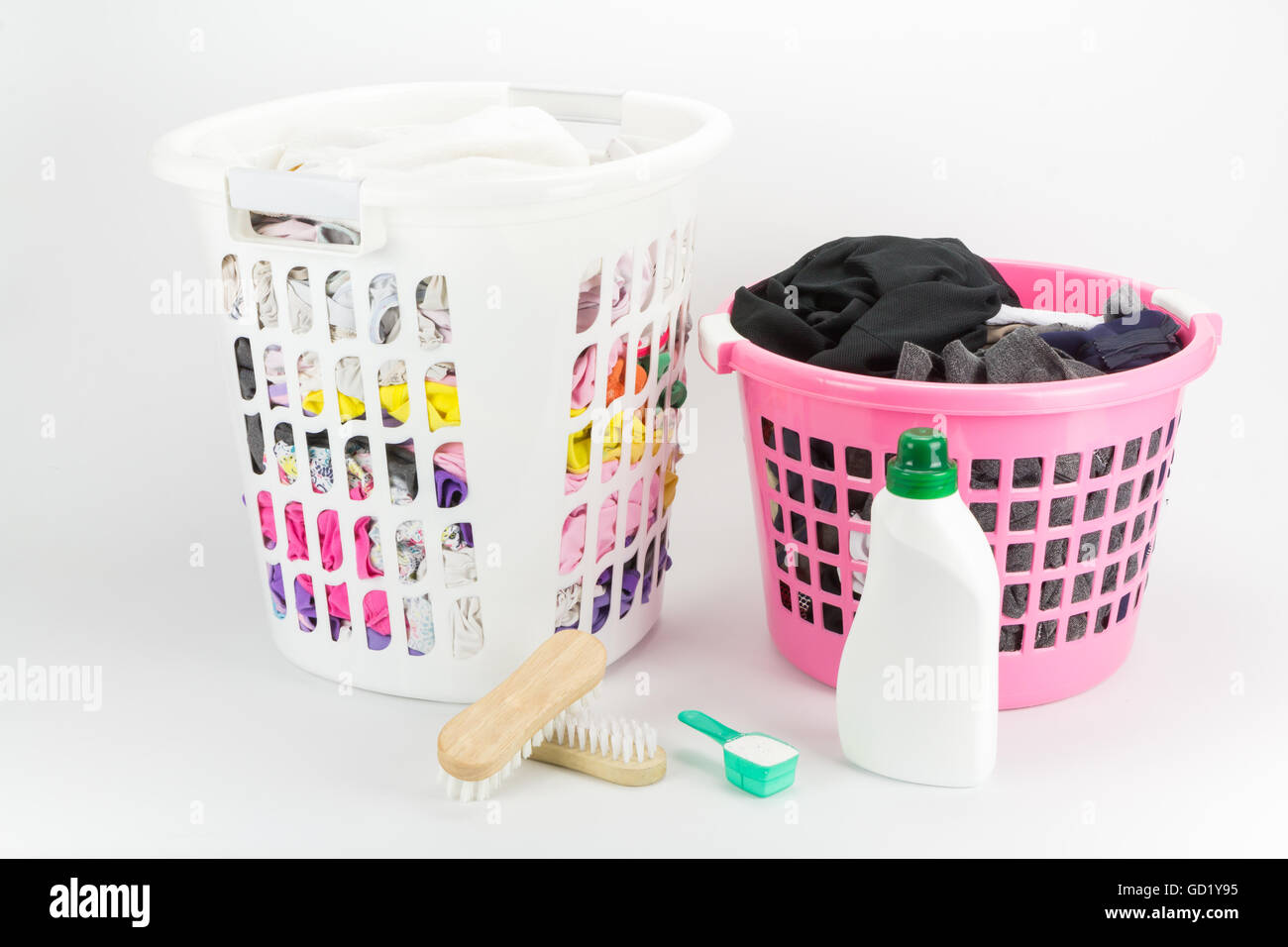 Basket of different clothes waiting for wash with washing powder ...