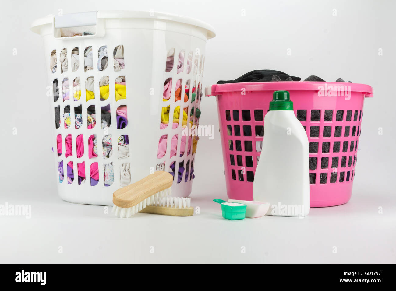 Basket of different clothes waiting for wash with washing powder ...