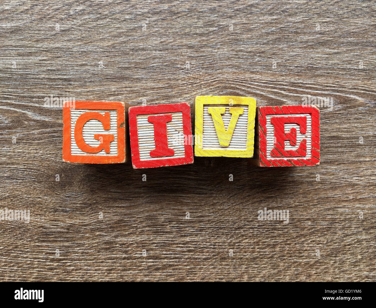 GIVE word written with wood block letter toys Stock Photo - Alamy