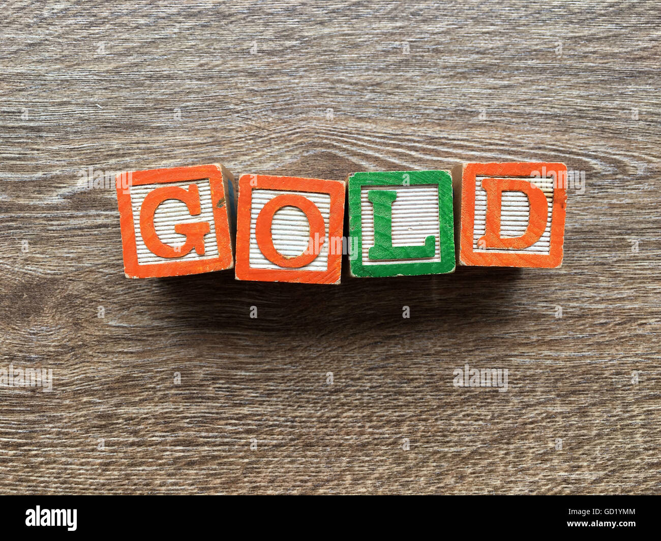 GOLD word written with wood block letter toys Stock Photo - Alamy