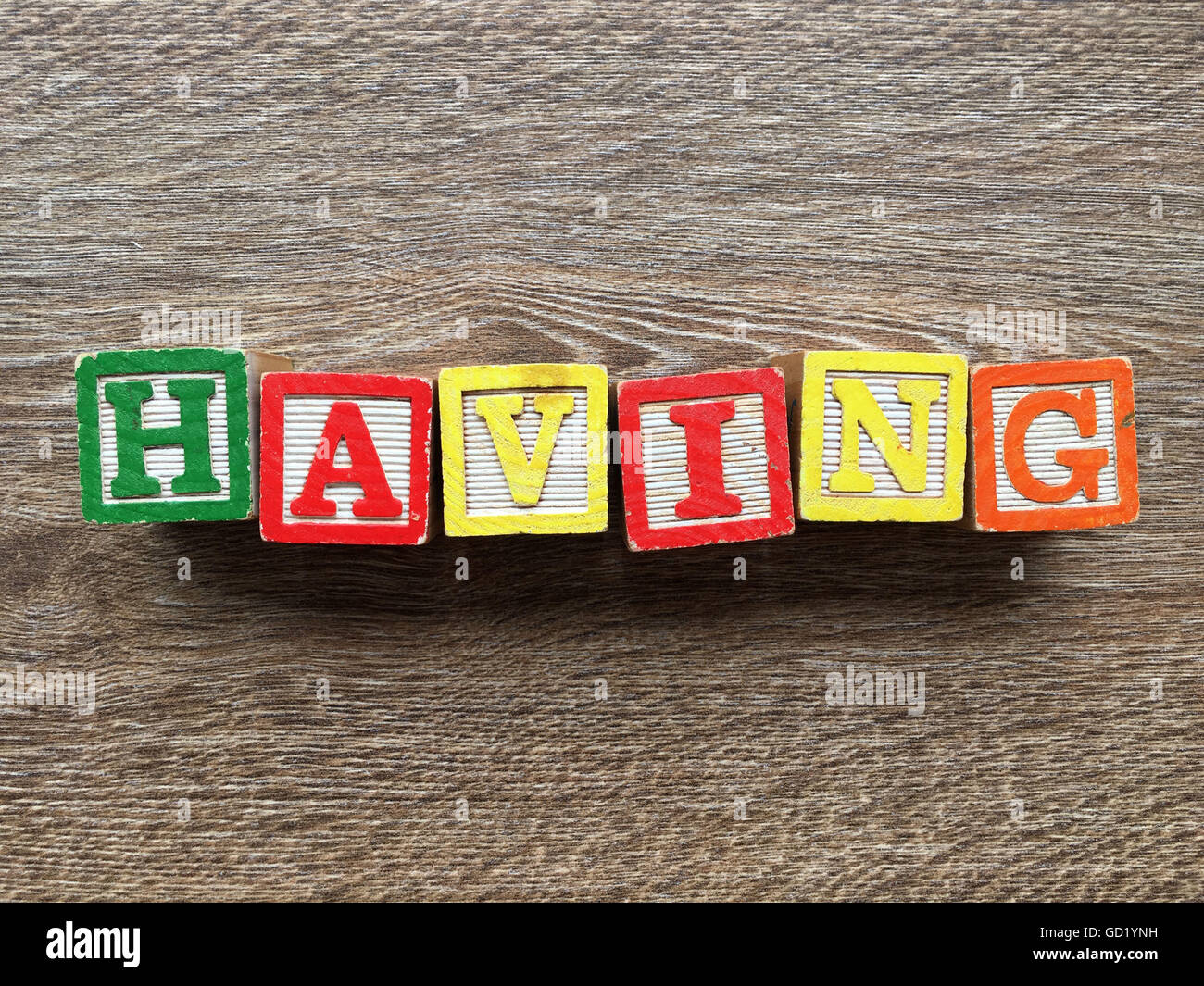 HAVING word done with wood block letter toys Stock Photo - Alamy