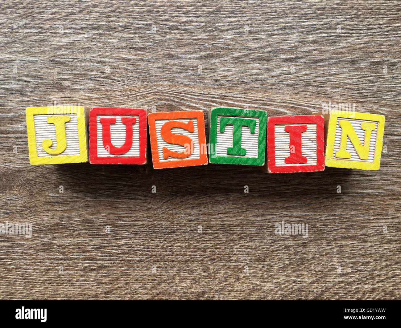 Justin name written with wood block letter toys Stock Photo - Alamy