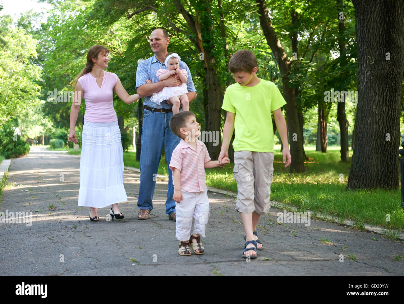happy family walking in city park, group of five people, summer season ...
