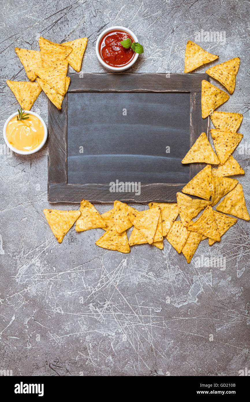 Mexican nacho with sauces and chalk board on gray background, top view ...
