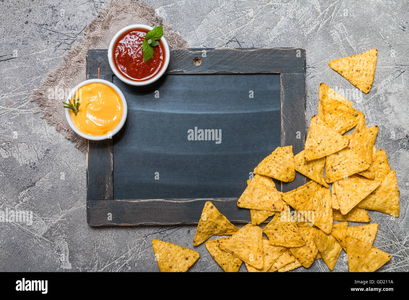Mexican nacho with sauces and chalk board on gray background, top view ...