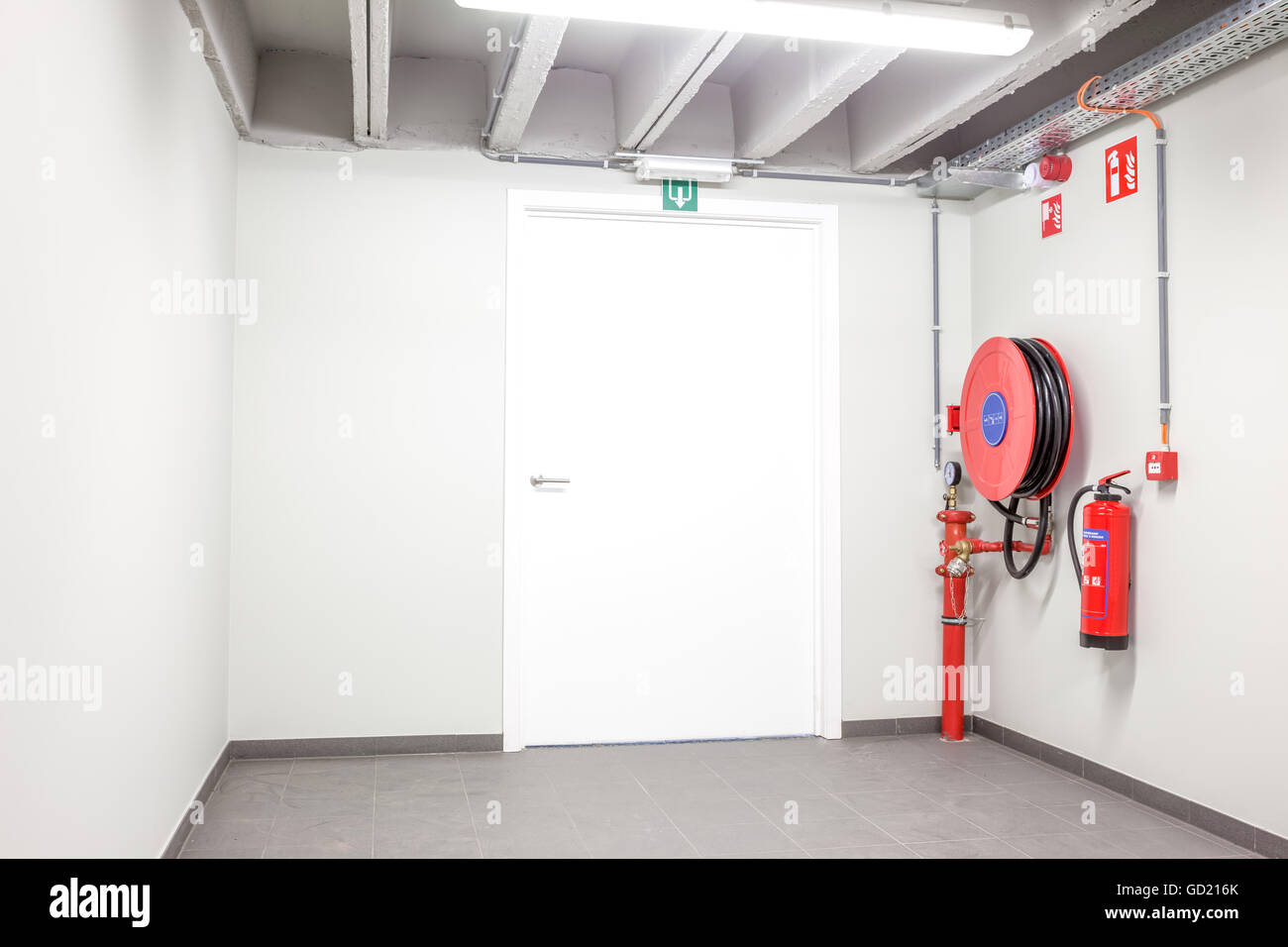 an fire hose hanging on the wall and powder extinguisher Stock Photo ...