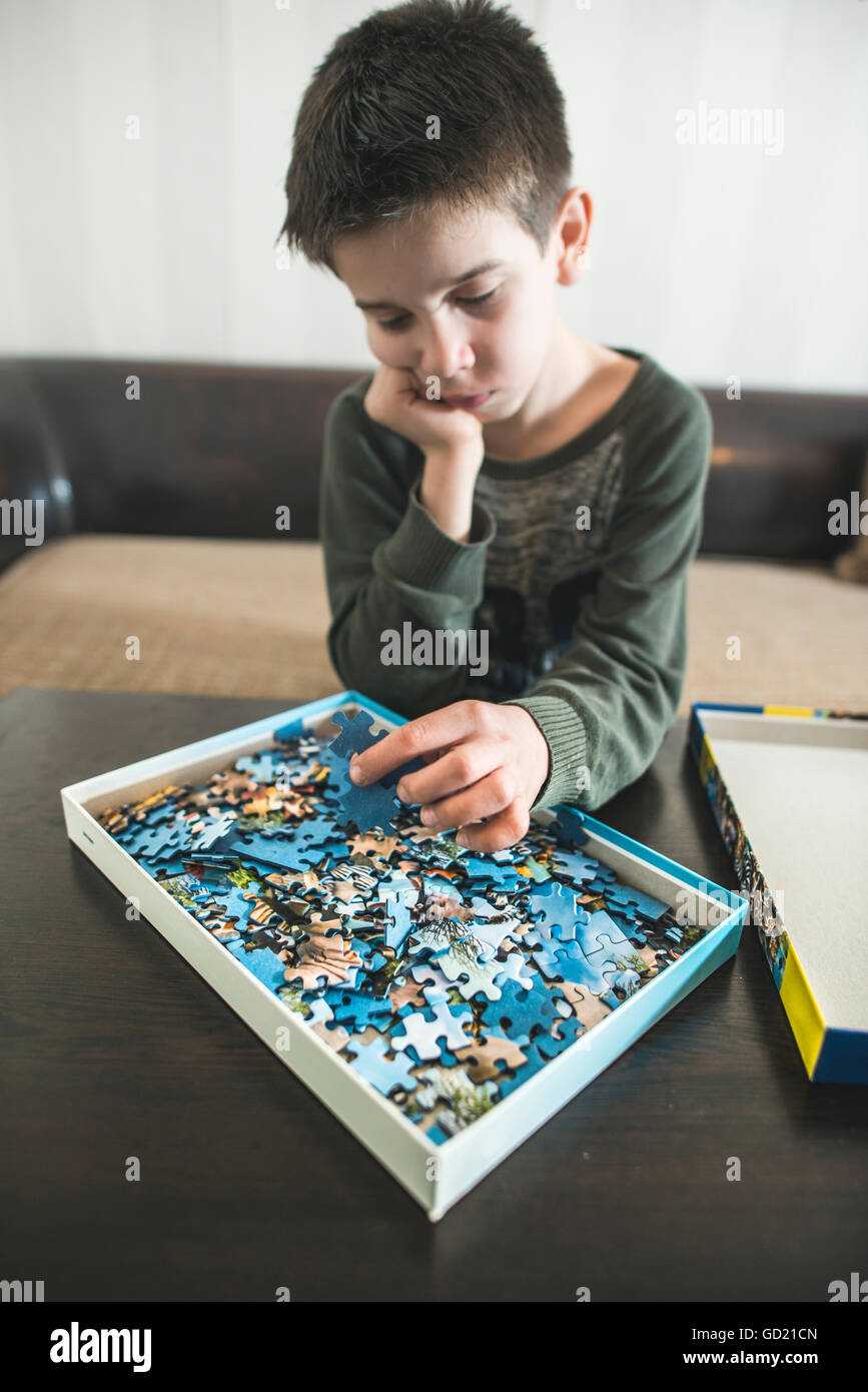 Child and puzzle. Pile puzzles Stock Photo - Alamy
