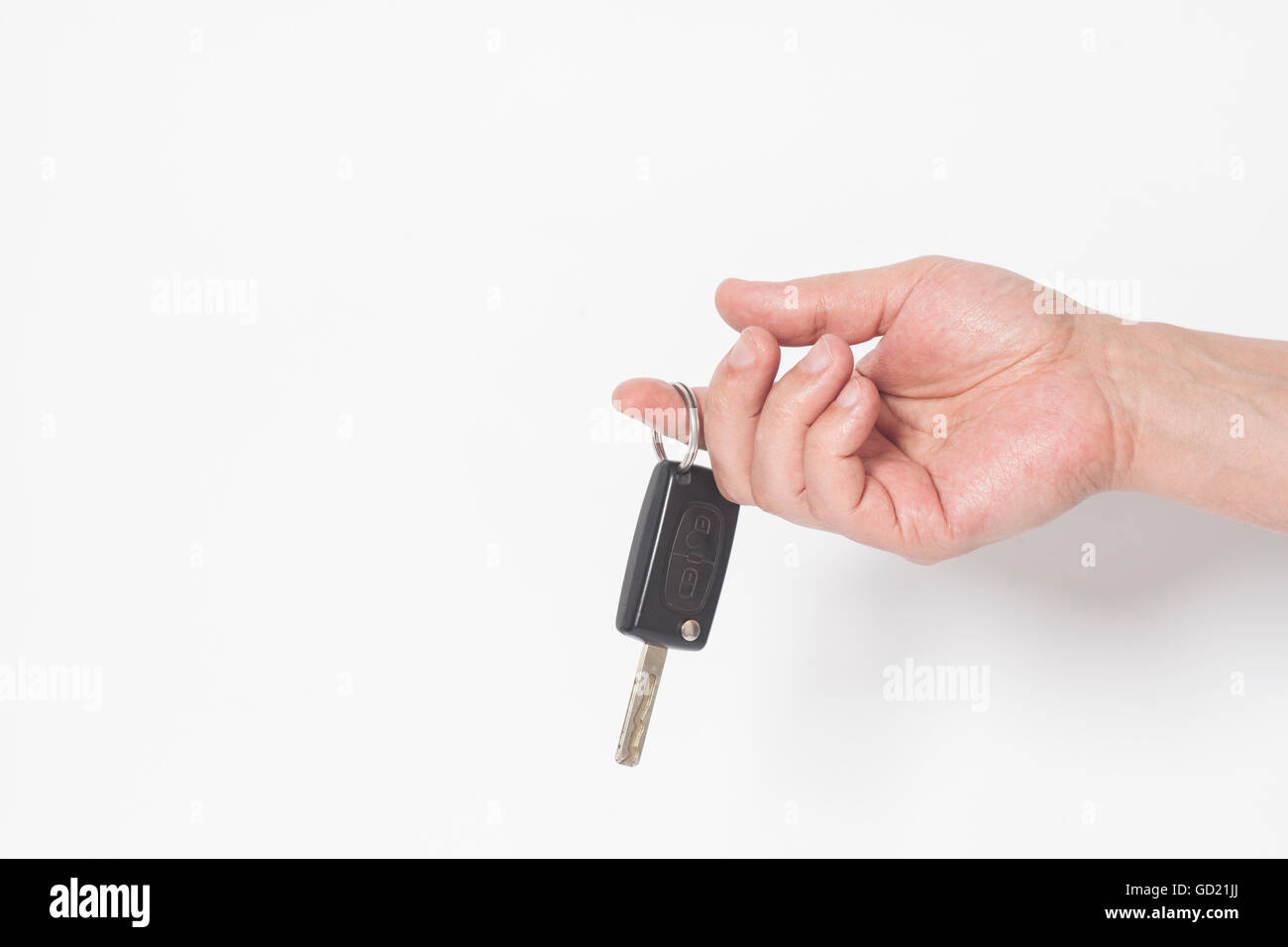 Hand with a car key on white background Stock Photo - Alamy