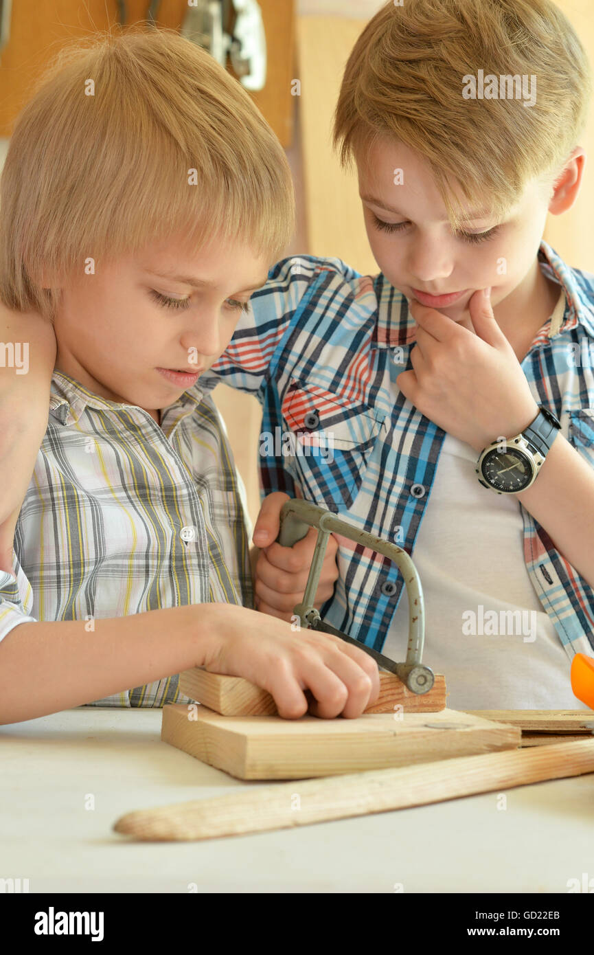 boys working with wood in workshop Stock Photo - Alamy