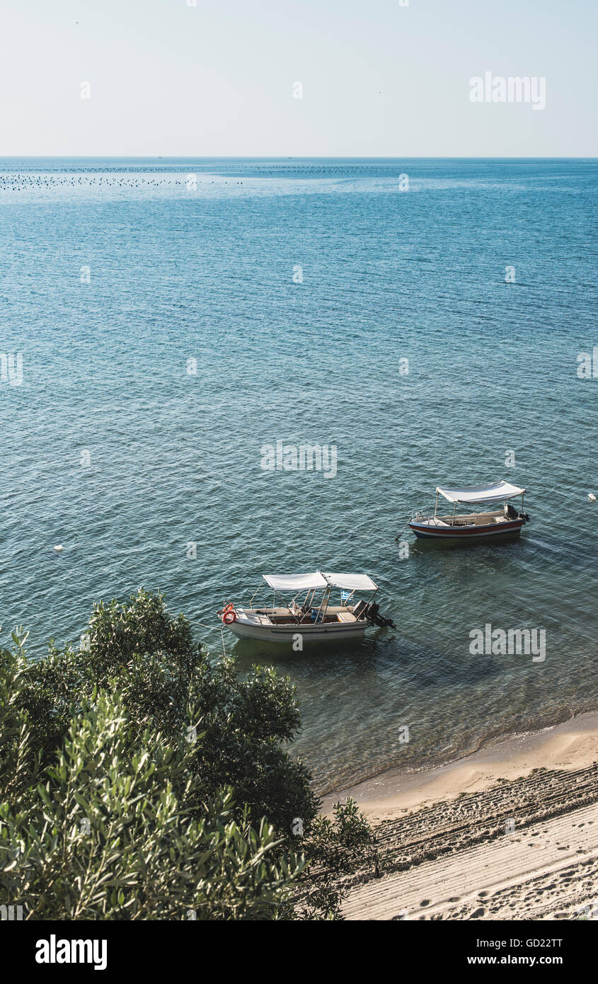 Fishing boats and cages for fish farming Stock Photo - Alamy