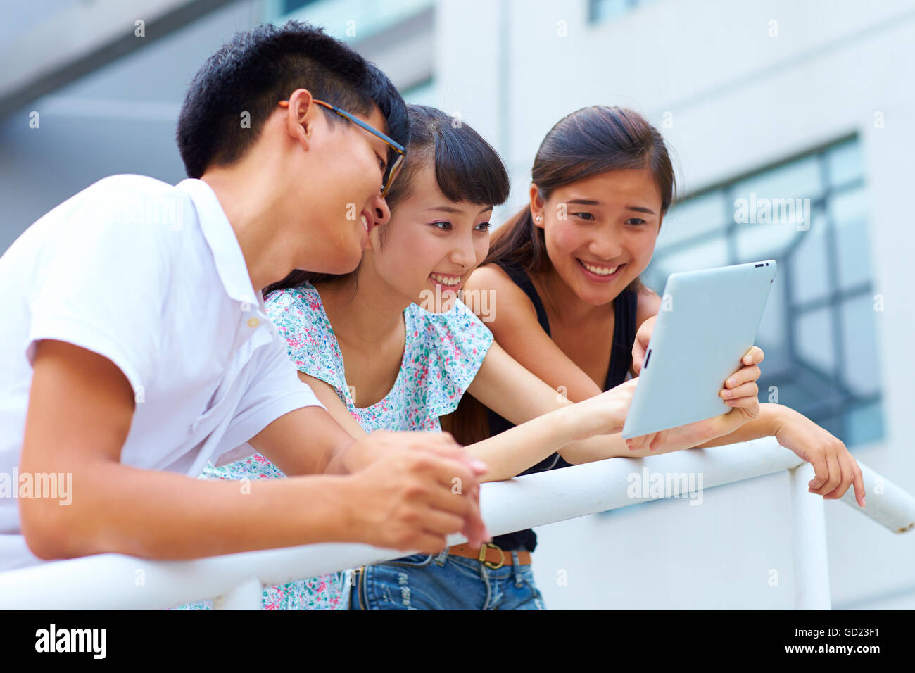happy young asian or Chinese people using tablet outdoor Stock Photo ...