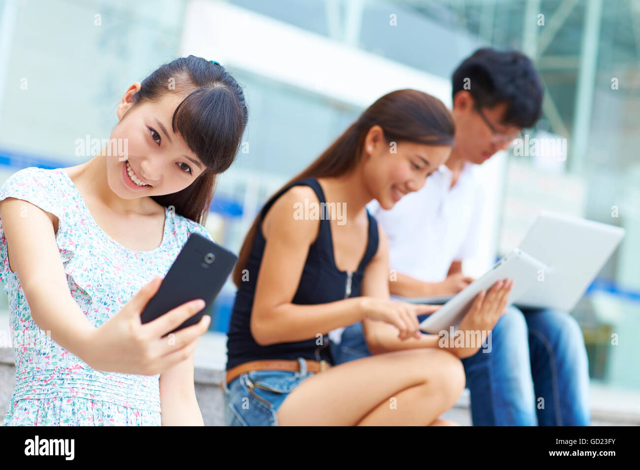 happy young asian or Chinese people using tablet outdoor Stock Photo ...