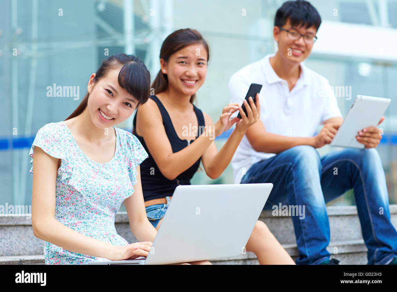 happy young asian or Chinese people using tablet outdoor Stock Photo ...