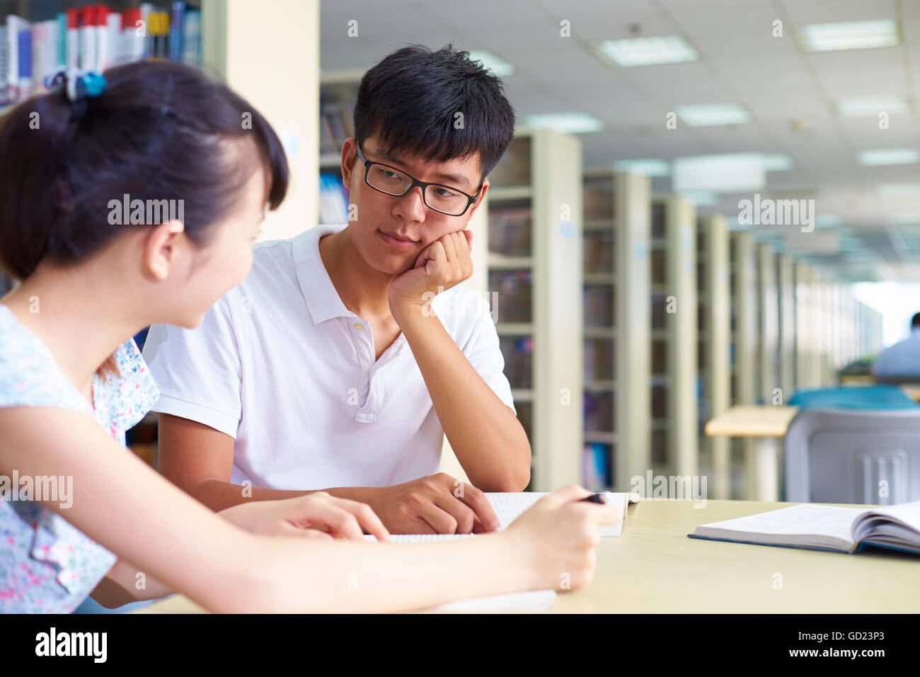 Young asian or Chinese college students study together in the library ...