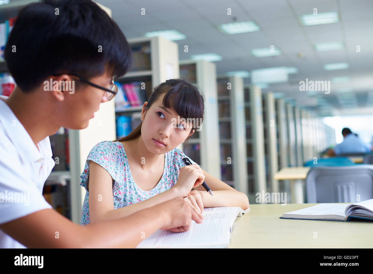 Young asian or Chinese college students study together in the library ...