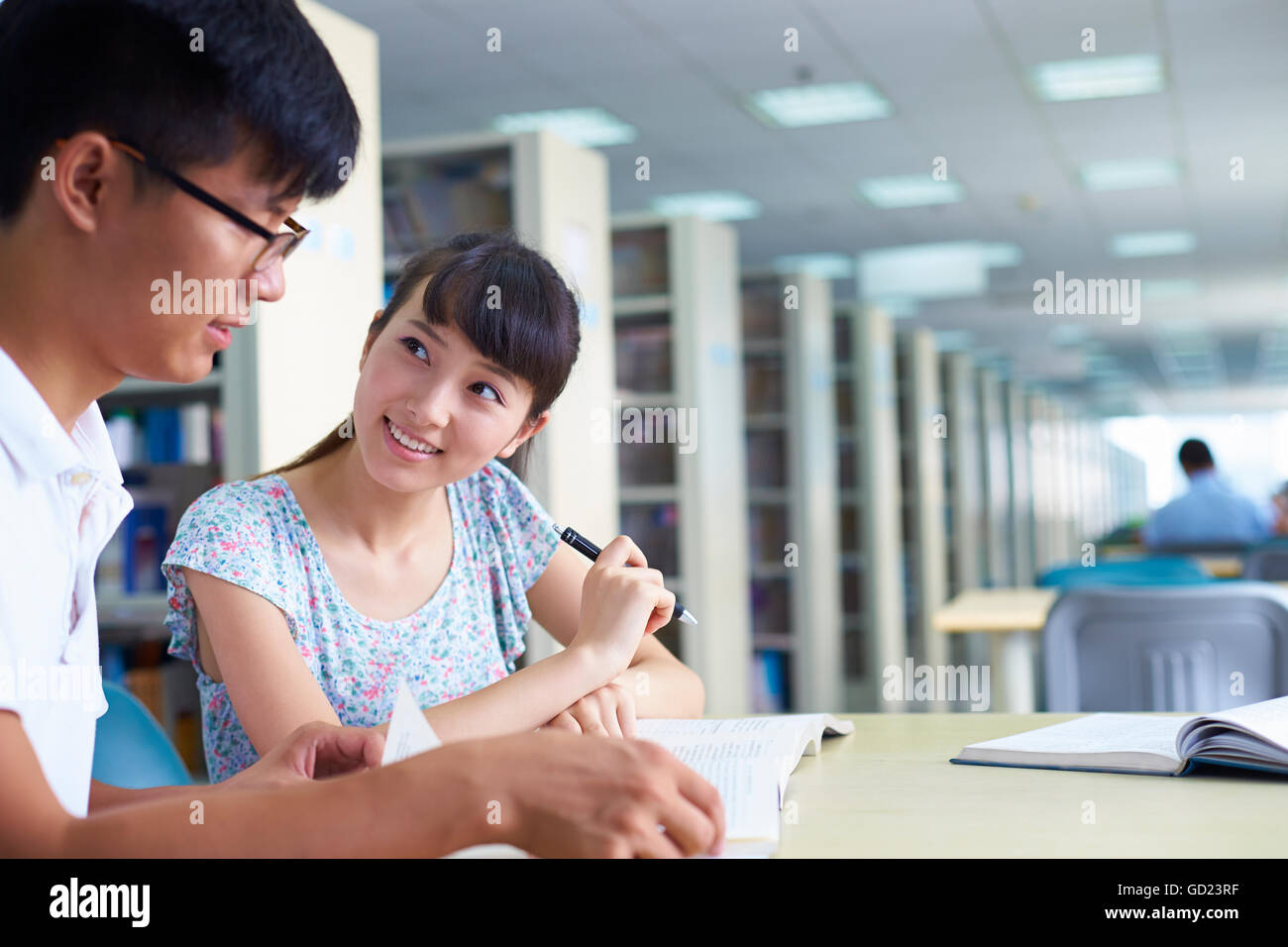 Young asian or Chinese college students study together in the library ...
