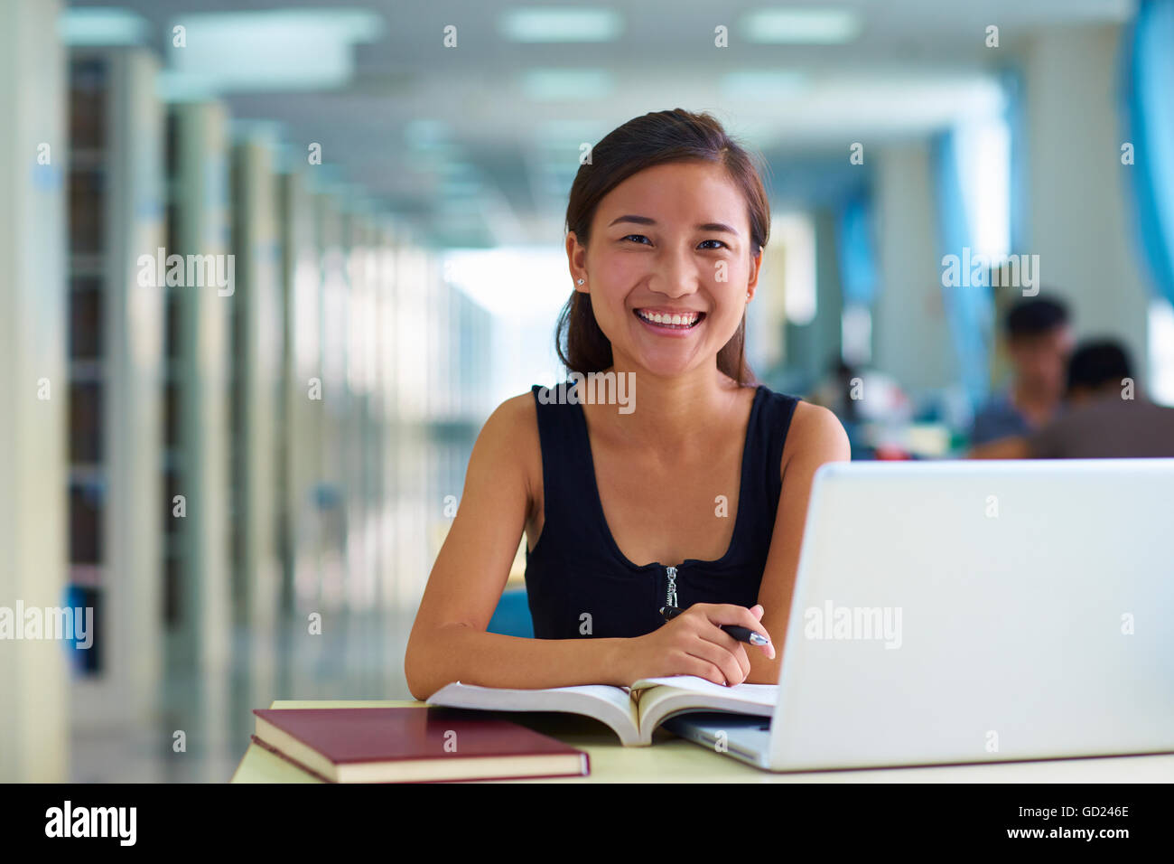 one pretty young Asian or Chinese college student study in the library ...