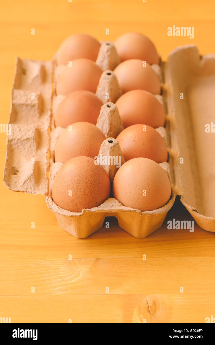 Ten chicken eggs in cardboard box, retro toned, selective focus Stock ...